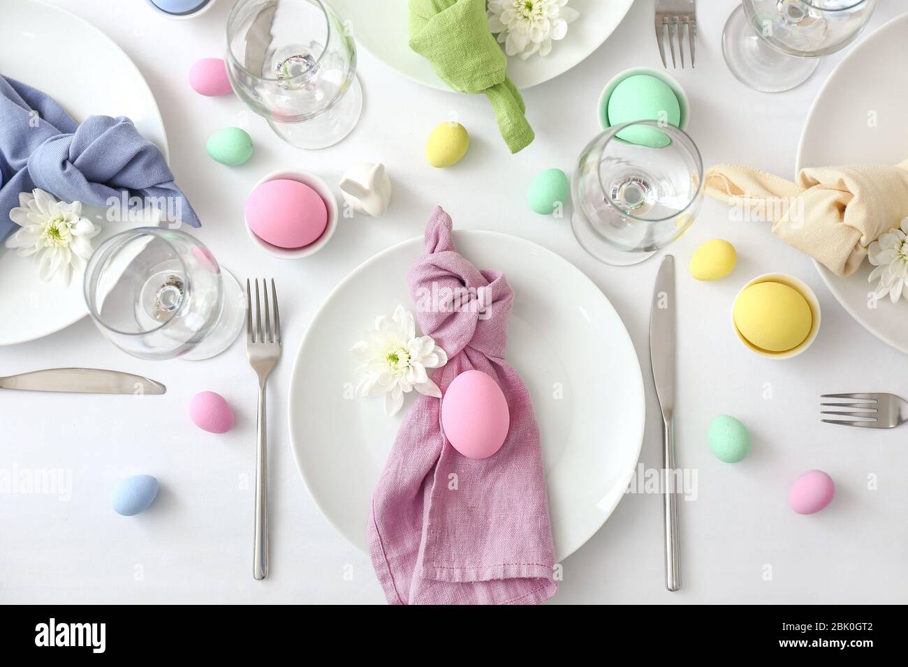 Table setting for Easter celebration on white background Stock Photo ...
