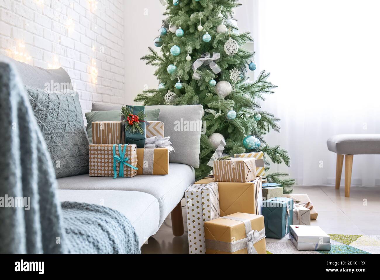 Interior of room with Christmas tree, sofa and many gifts Stock Photo ...