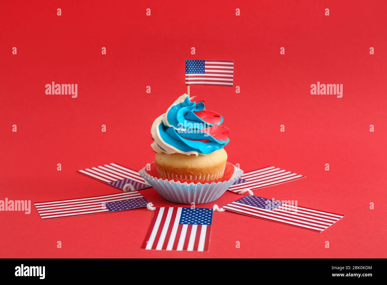 Tasty patriotic cupcake and USA flags on color background Stock Photo ...