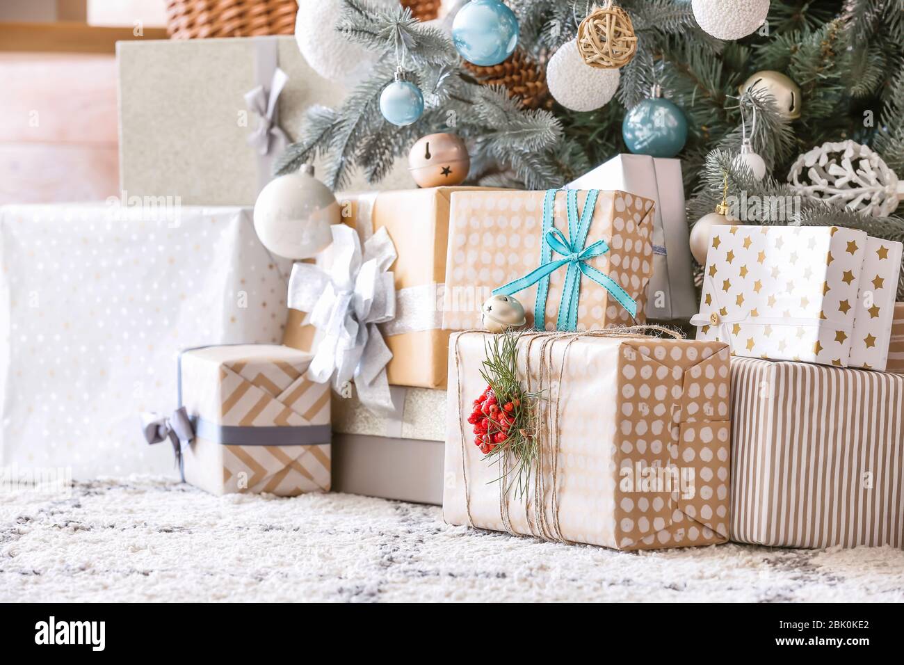 Many beautiful gift boxes under Christmas tree Stock Photo - Alamy
