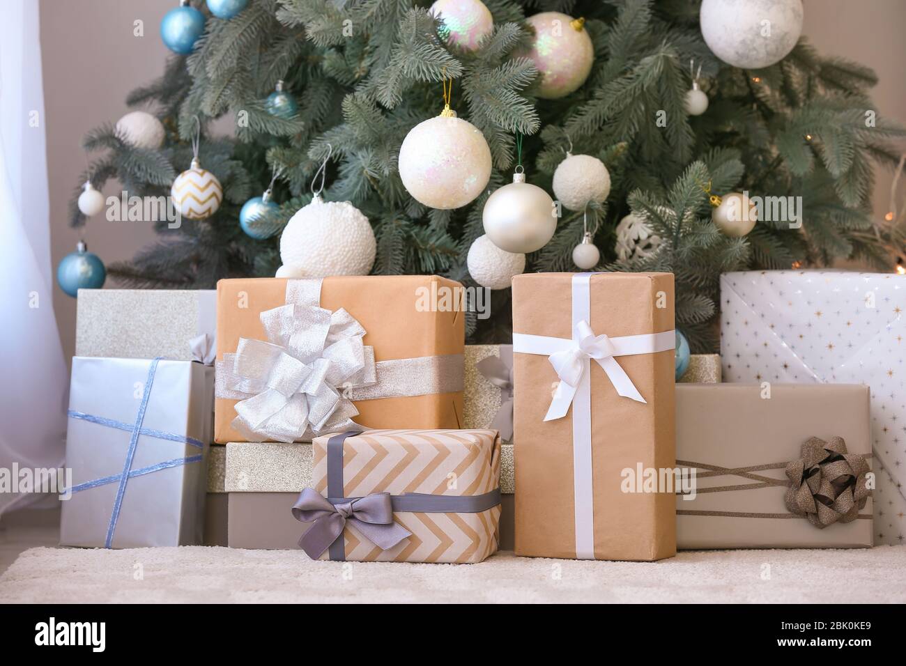 Many beautiful gift boxes under Christmas tree Stock Photo - Alamy