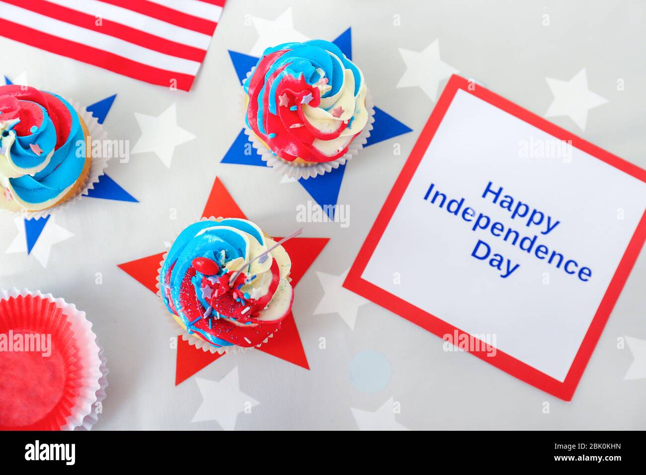 Tasty patriotic cupcakes and card for Independence Day on table Stock ...