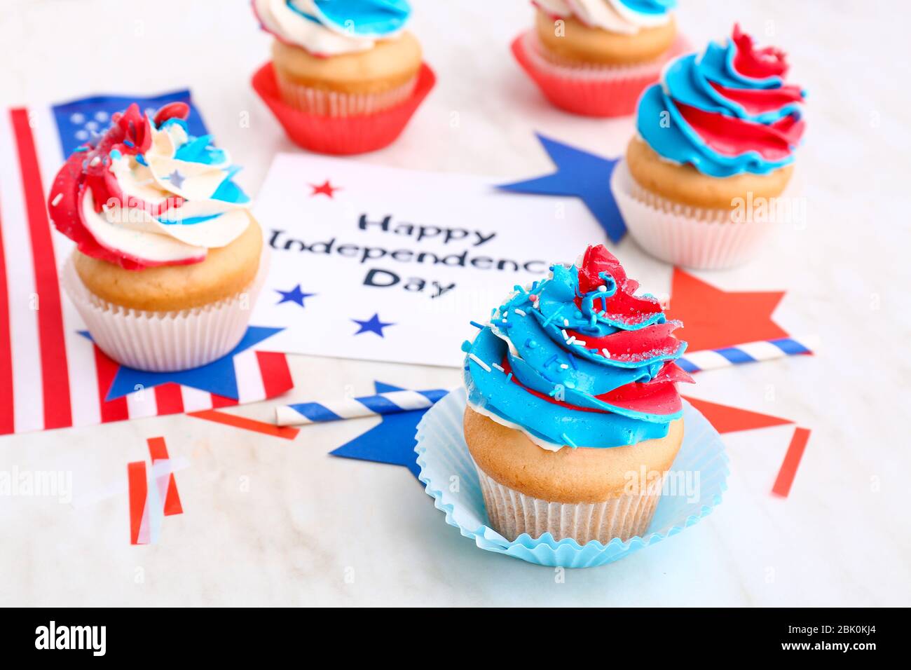 Tasty patriotic cupcakes and card for Independence Day on table Stock ...