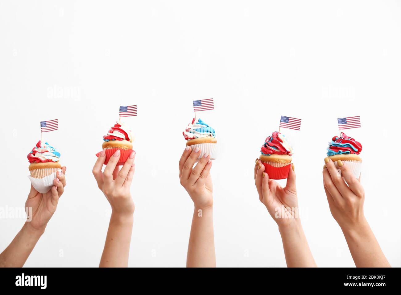 Female hands with tasty patriotic cupcakes on white background Stock ...