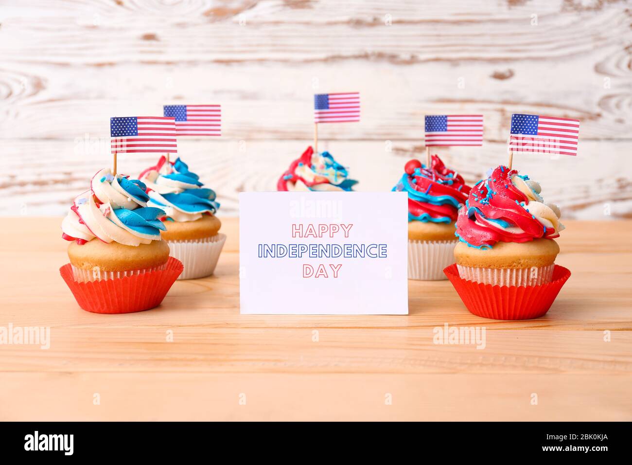 Tasty patriotic cupcakes and card for Independence Day on table Stock ...