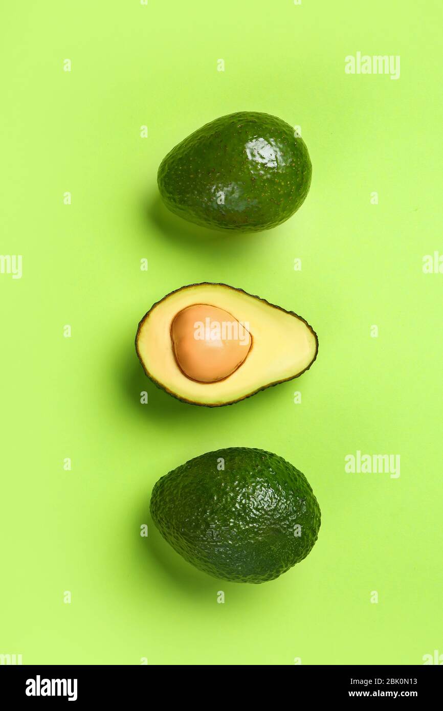 Ripe avocados on color background Stock Photo - Alamy