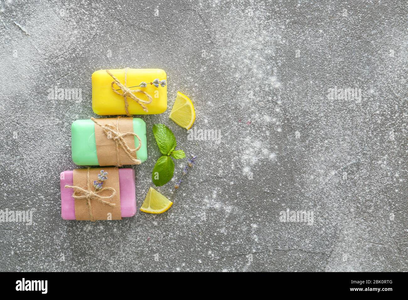 Different soap on grey background Stock Photo - Alamy