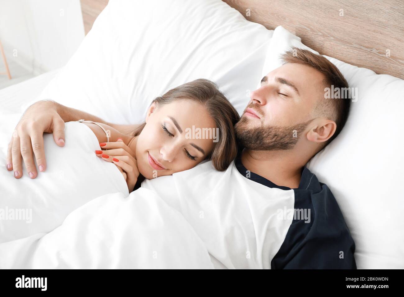 Morning of young couple sleeping in bed Stock Photo - Alamy