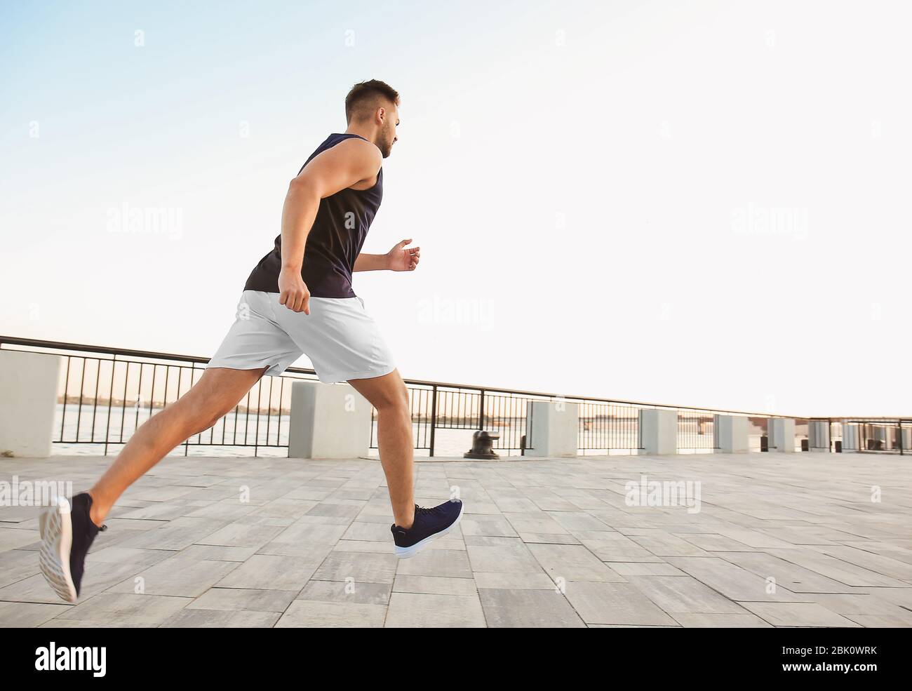 Handsome sporty man running outdoors Stock Photo - Alamy