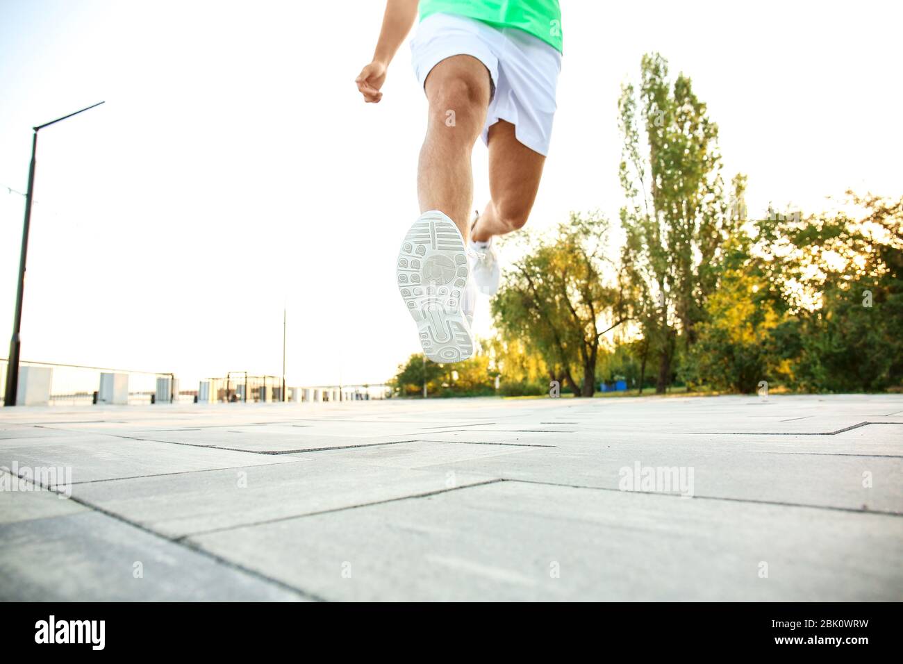 Handsome sporty man running outdoors Stock Photo - Alamy