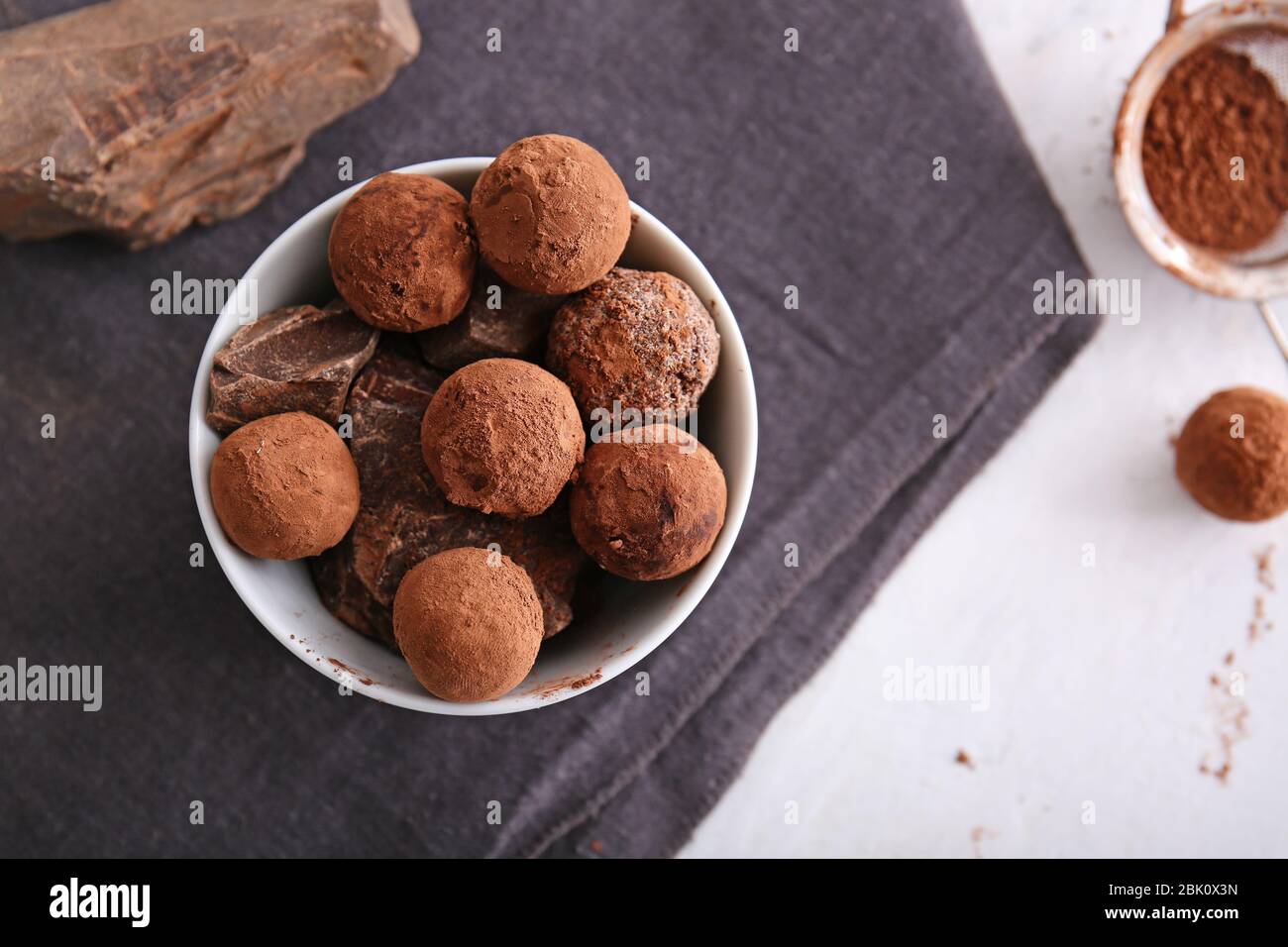 Tasty sweet truffles in bowl on table Stock Photo - Alamy