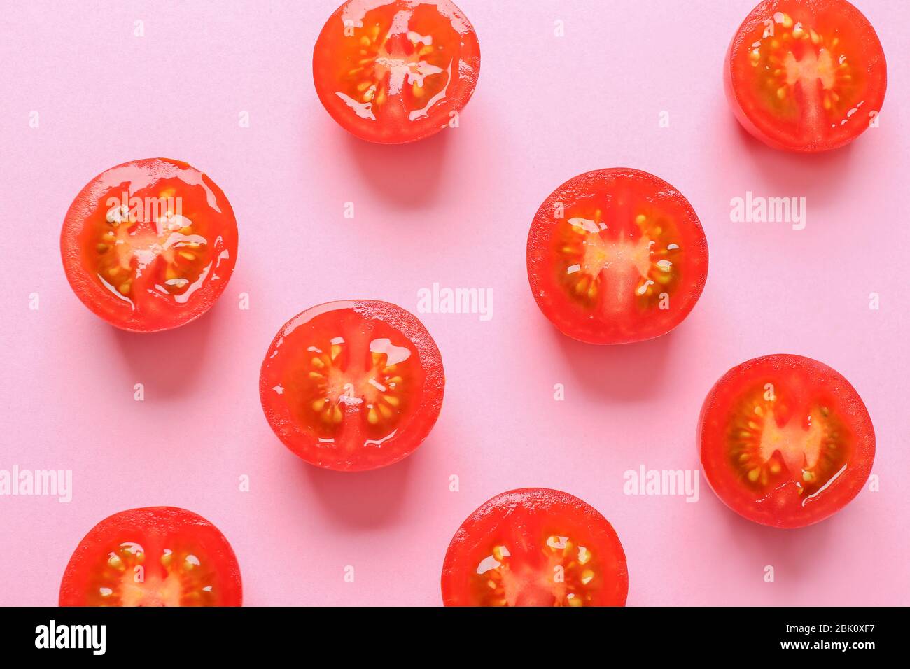 Many cut tomatoes on color background Stock Photo - Alamy