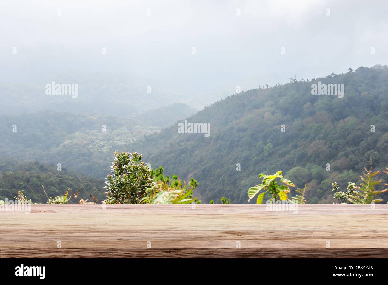 Wooden table light brown color with of mountain and fog a background ...