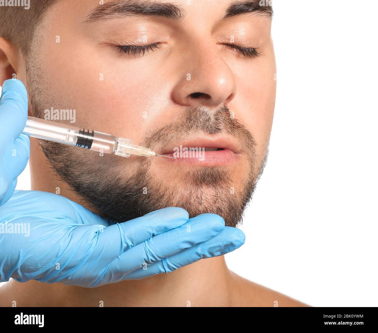 Handsome man receiving filler injection on white background, closeup ...