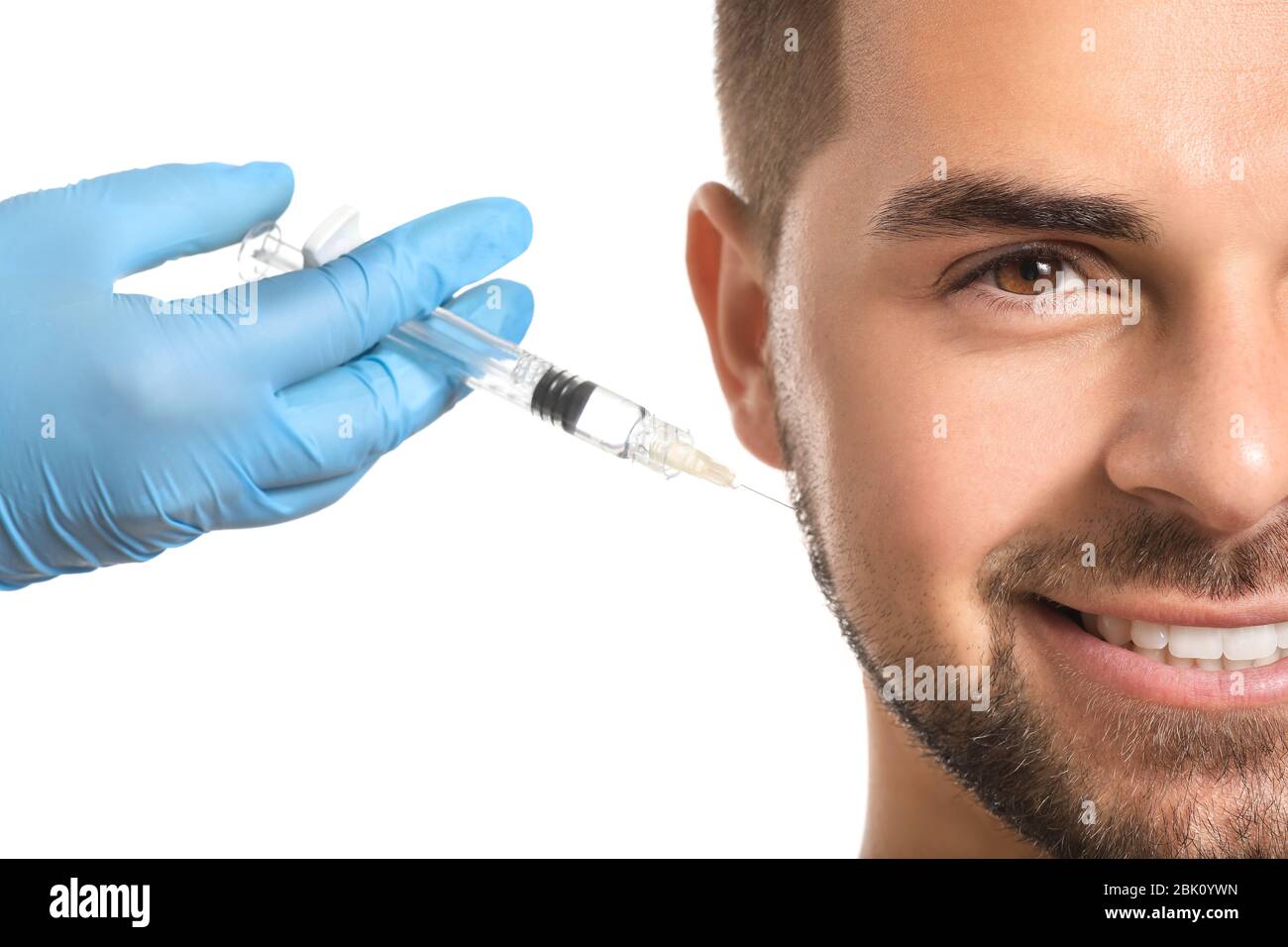 Handsome man receiving filler injection on white background, closeup ...