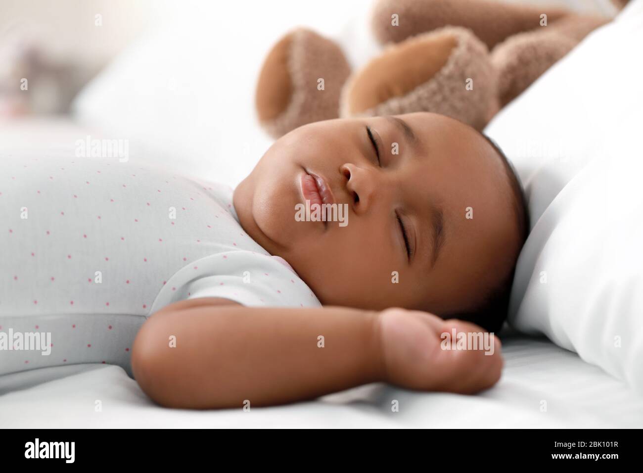 Cute African-American baby sleeping on bed Stock Photo - Alamy