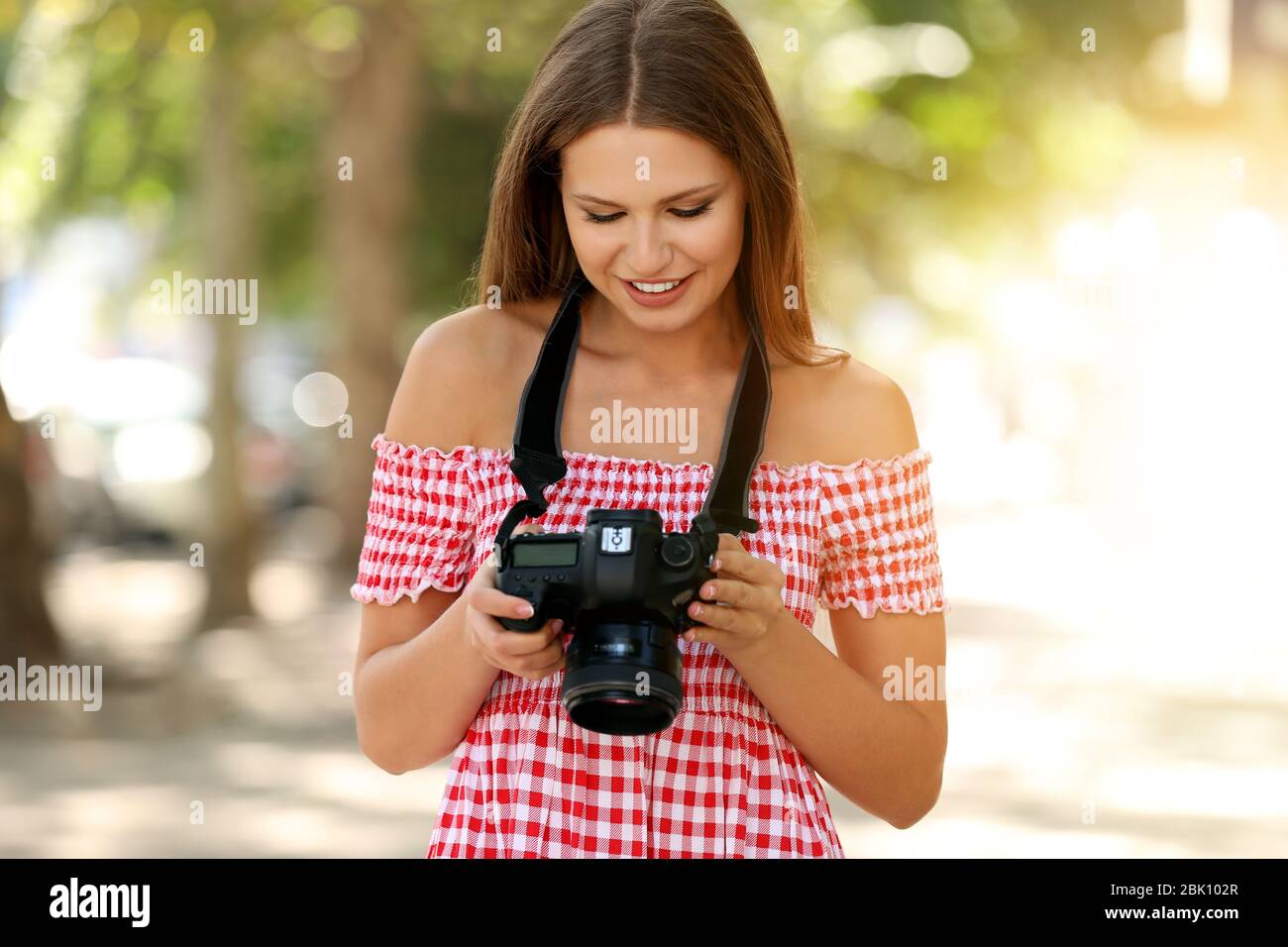 Beautiful female photographer with camera outdoors Stock Photo - Alamy