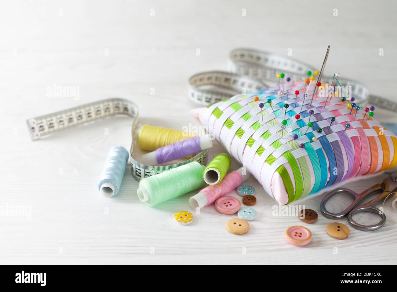 Needle box, threads and cotton fabrics for sewing. White background ...