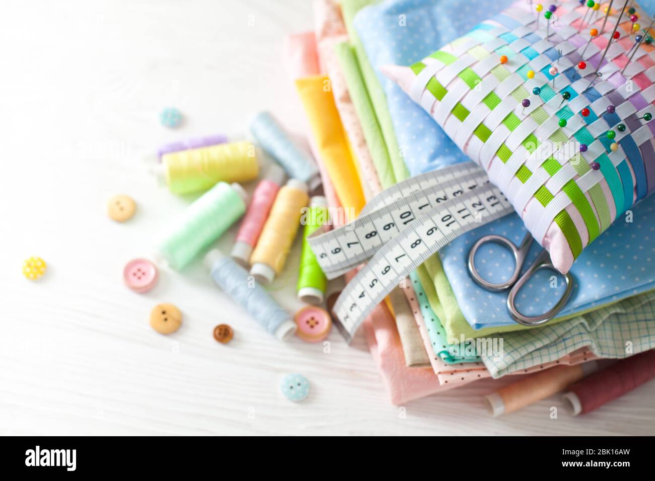 Needle box, threads and cotton fabrics for sewing. White background ...