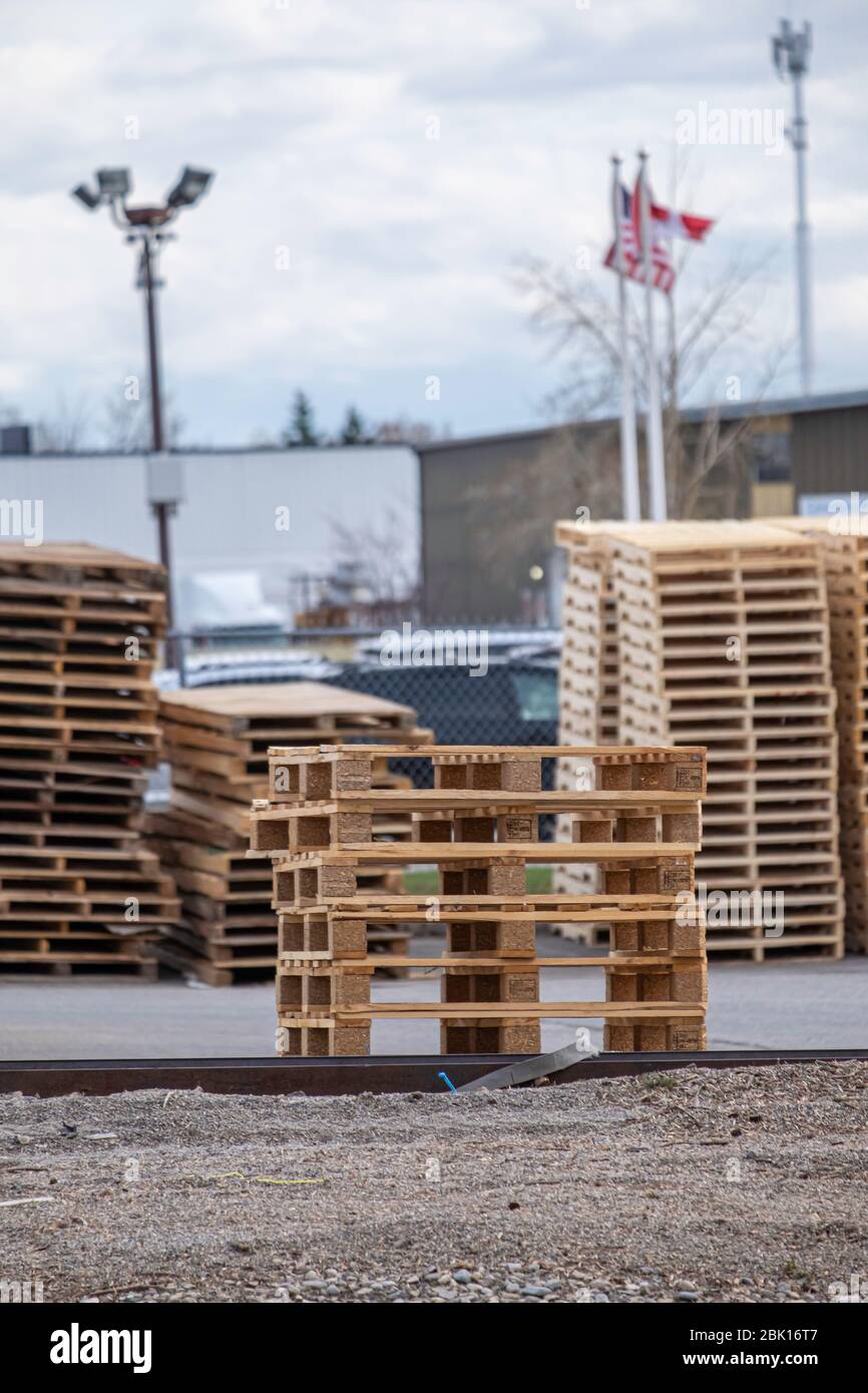 Stacks of Wooden Pallets in factory Stock Photo - Alamy