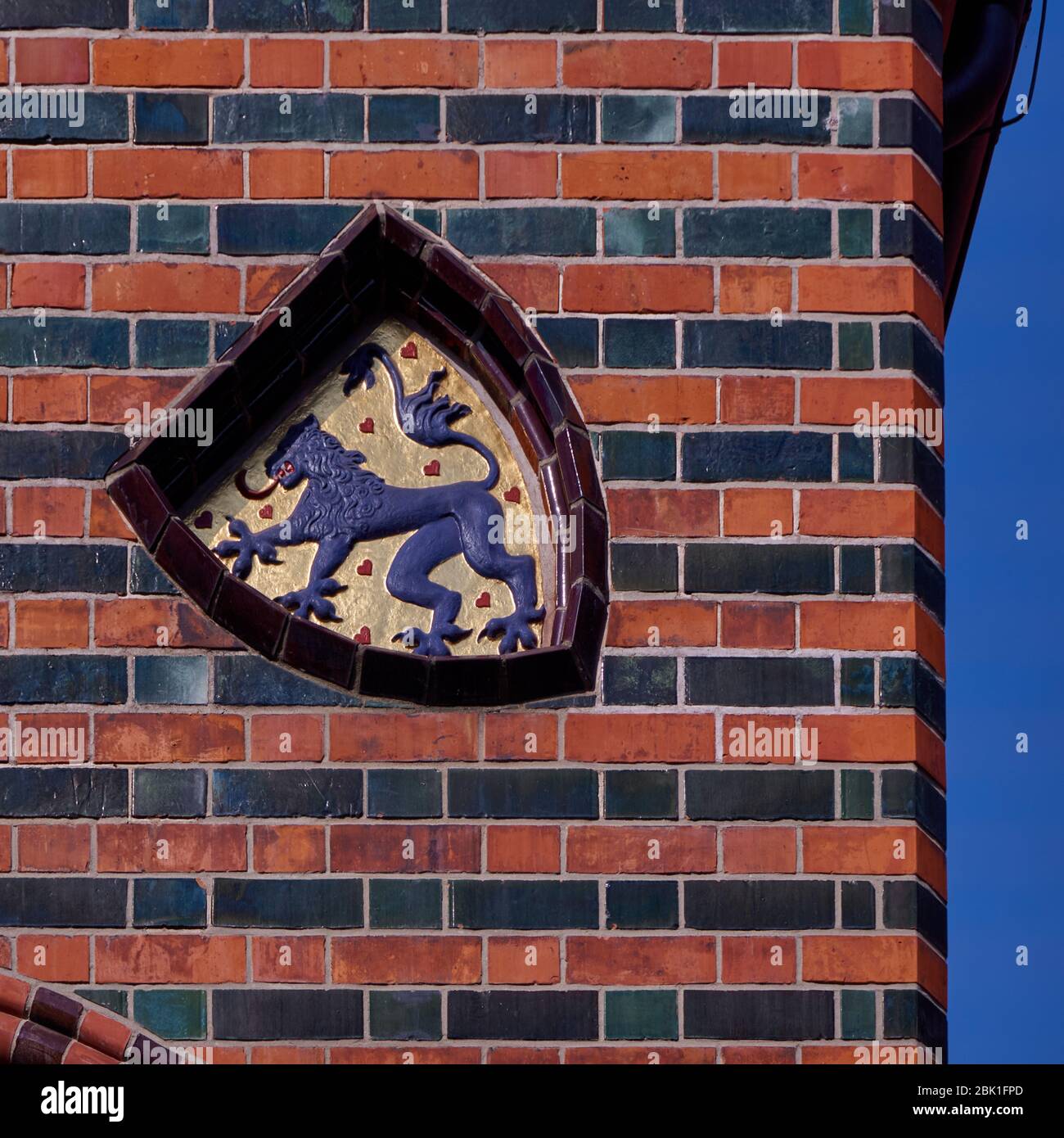 Coat of arms with a lion, standing upright, on the brick wall of the ...