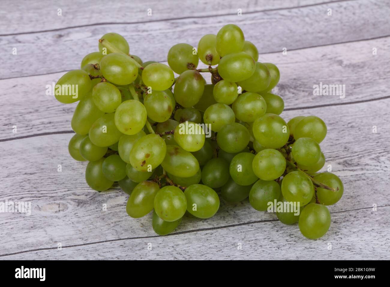 Sweet green grape branch over background Stock Photo - Alamy