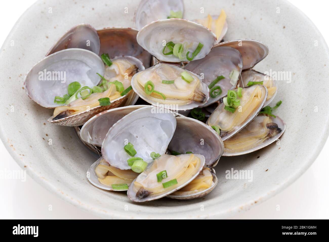 Japanese traditional cuisine, Sake steamed clams, Sakamushi, on table ...