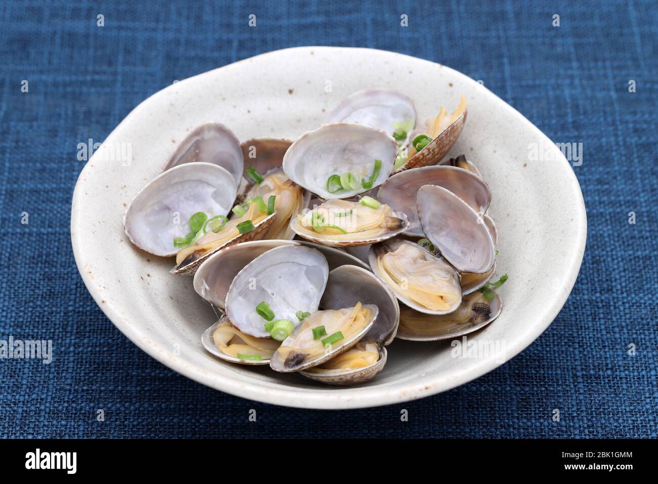 Japanese traditional cuisine, Sake steamed clams, Sakamushi, on table ...