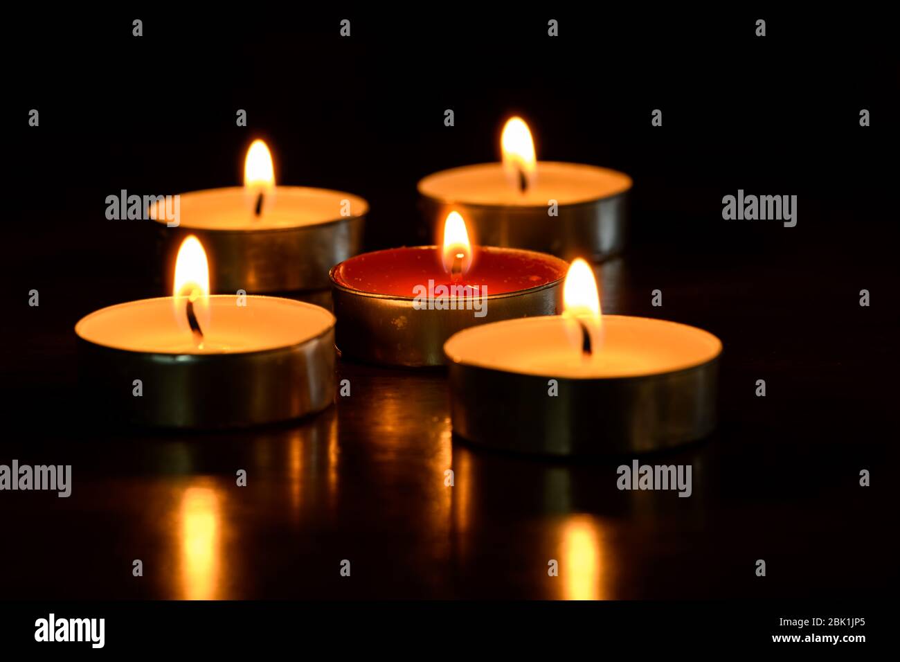 Romantic small lit candles Stock Photo - Alamy