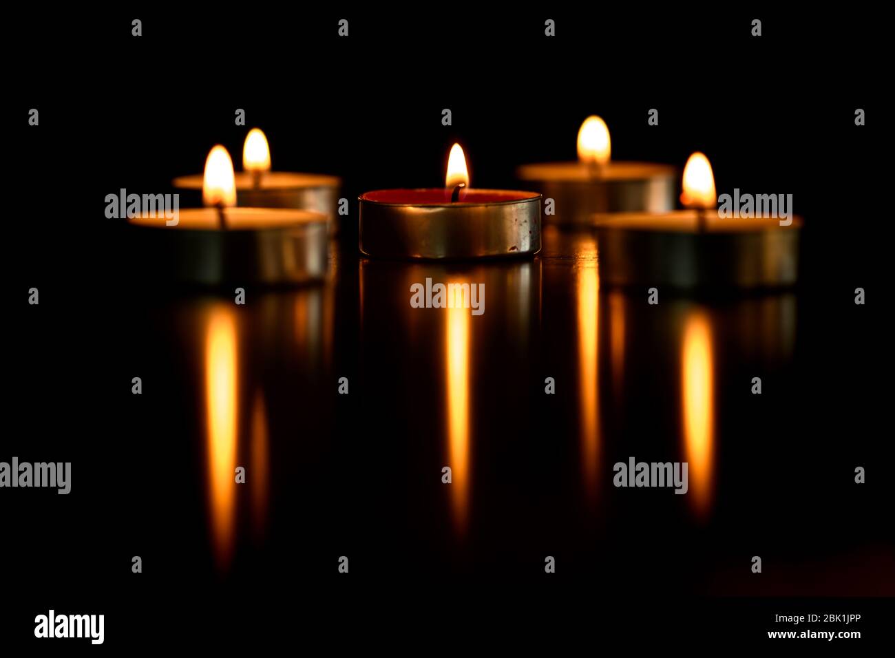 Romantic small lit candles Stock Photo - Alamy