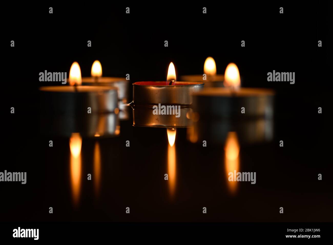 Romantic small lit candles Stock Photo - Alamy