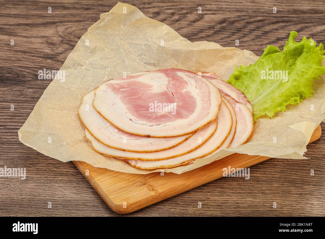 Sliced Italian Pancetta sausage over board Stock Photo - Alamy