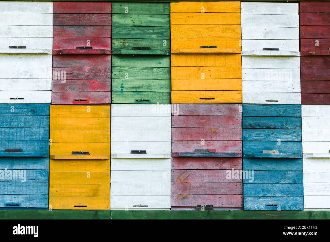 White, red, green, yellow and blue honey beekeeping boxes. Colorful ...