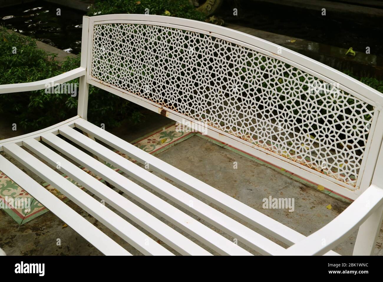Empty white colored iron bench in the garden Stock Photo - Alamy