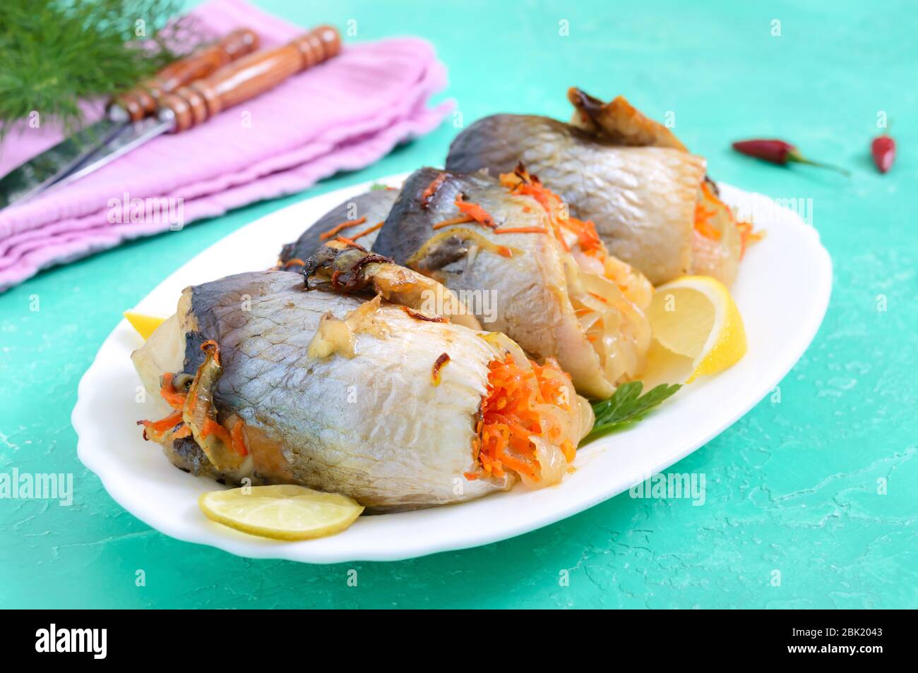 Baked herring stuffed with vegetables. Tasty fish rolls Stock Photo - Alamy