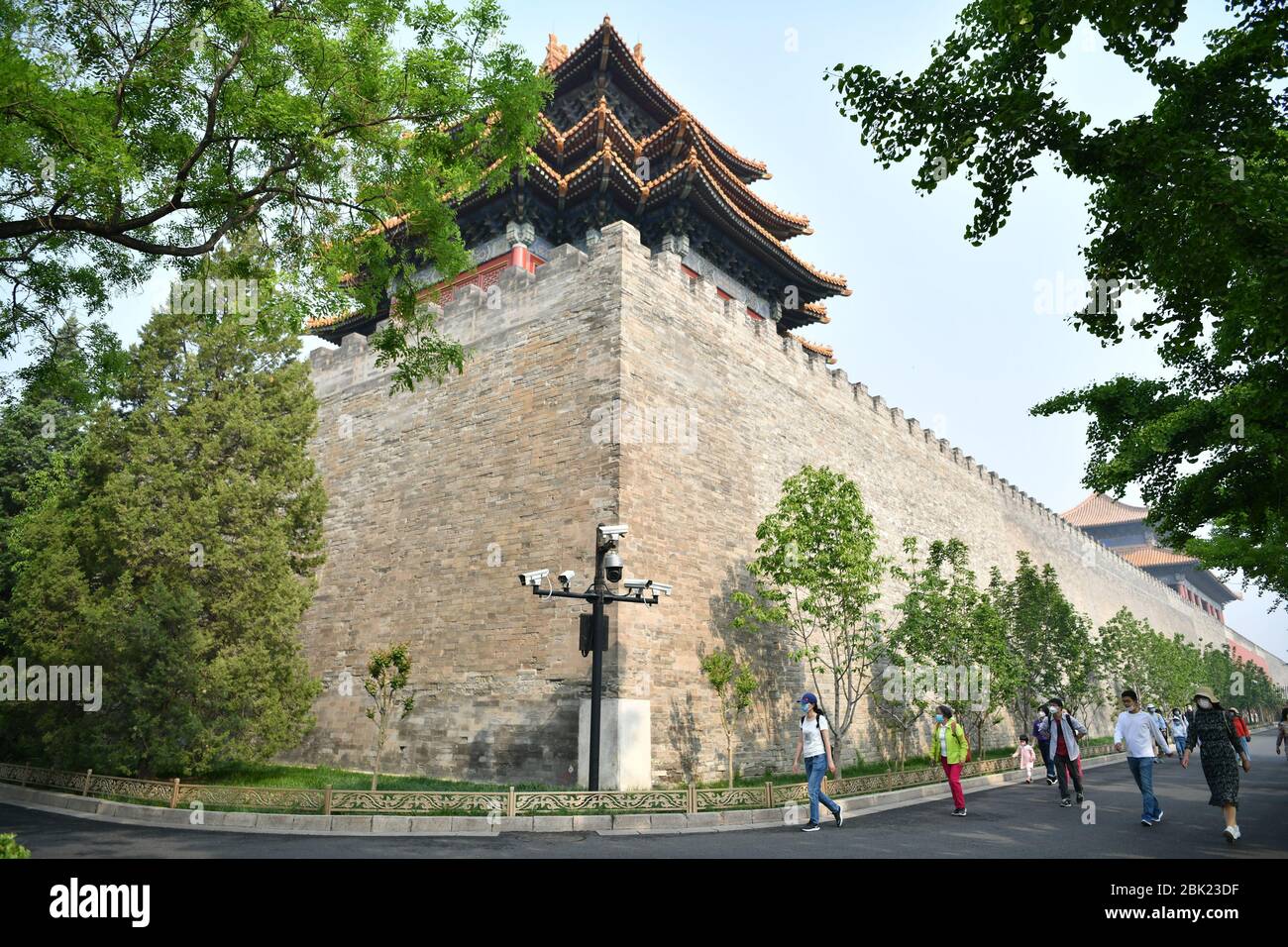Beijing, China. 1st May, 2020. Visitors walk by the ancient wall of the ...