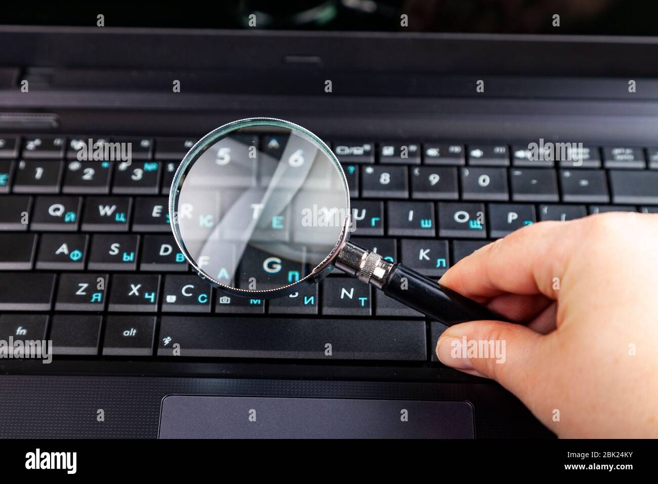 Hand with magnifier on a laptop background. Computer techologies Stock ...