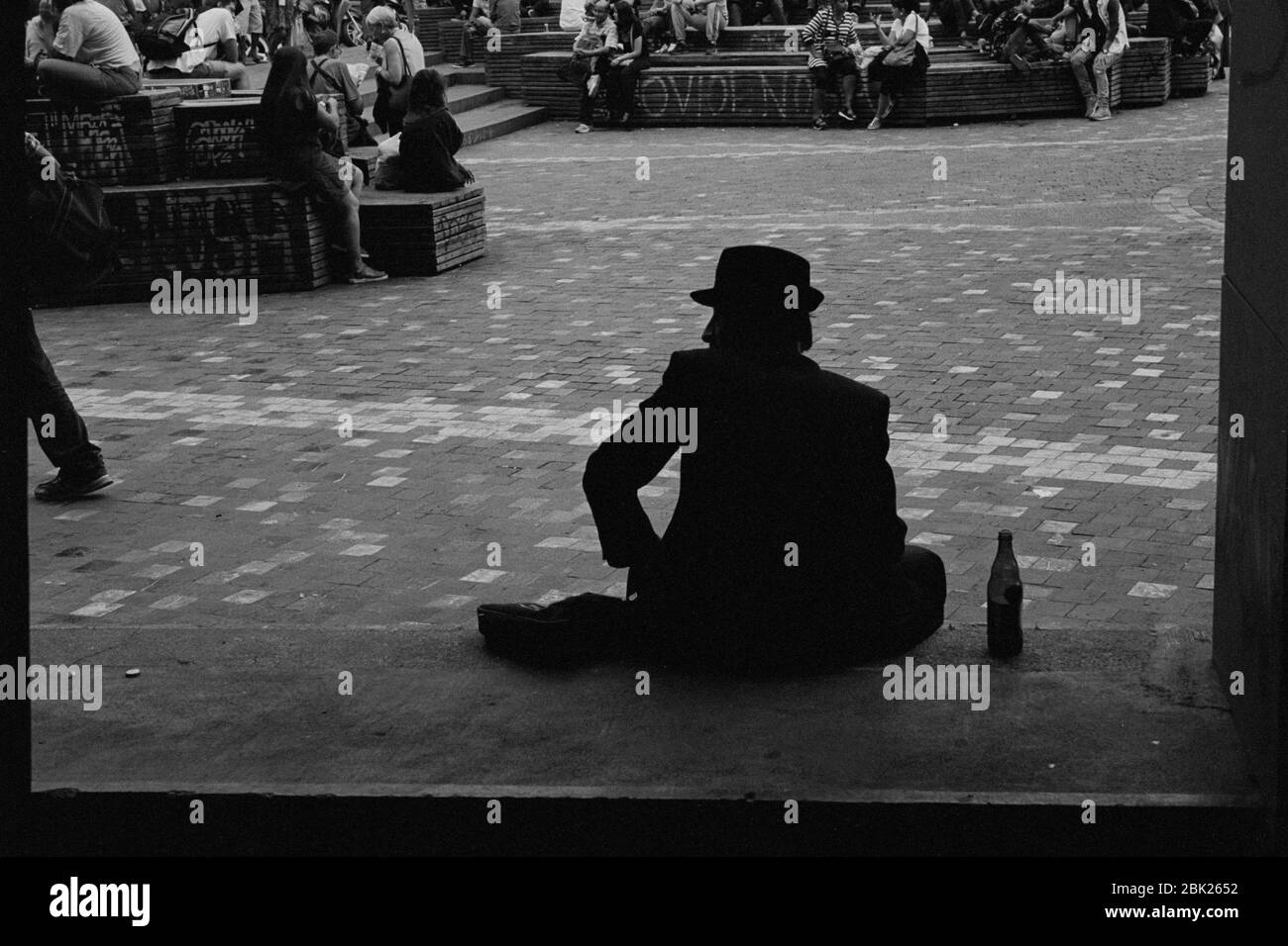 Man sitting in square Black and White Stock Photos & Images - Alamy