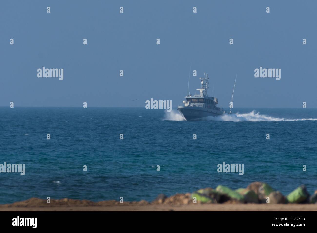 Navy warship fleet speed through the gulf water towards shore in combat ...