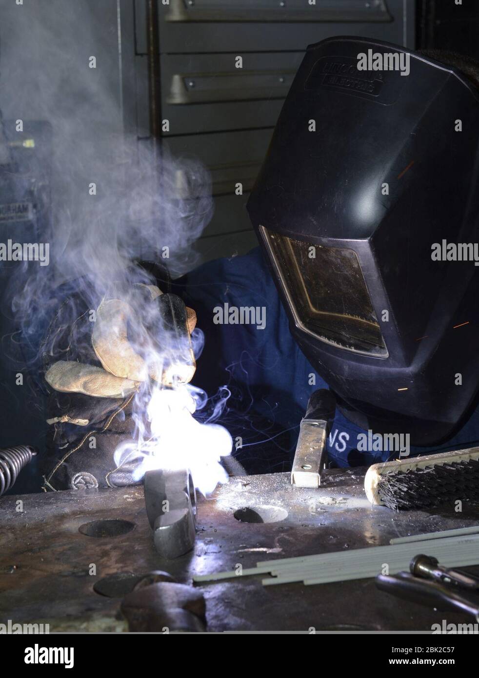 U.S. Navy Hull Maintenance Technician 2nd Class performs a welding ...