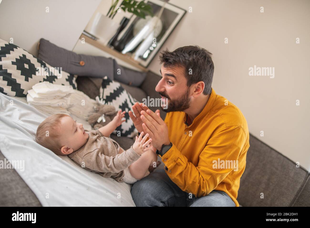 Father and baby.Young dad is changing baby diaper.Happiness and harmony ...