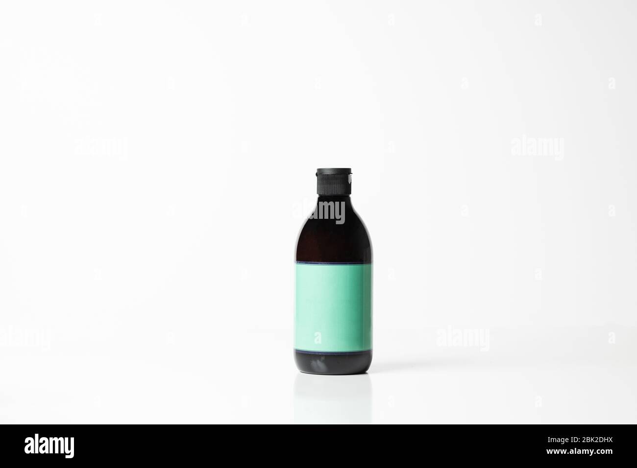 Black plastic bottle color label on a white background Stock Photo - Alamy