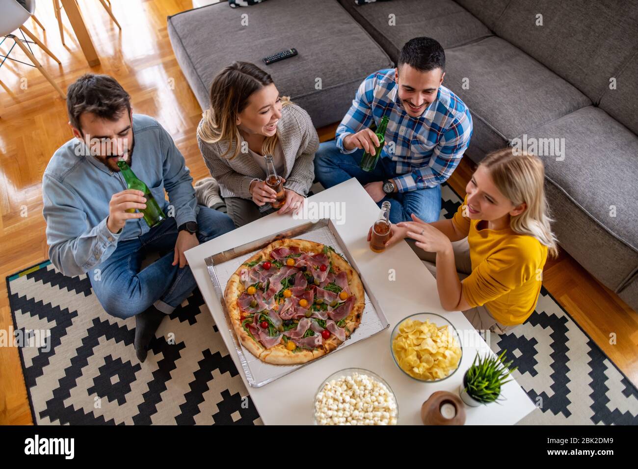 Friends having fun at party with delicious pizza.People sharing pizza ...