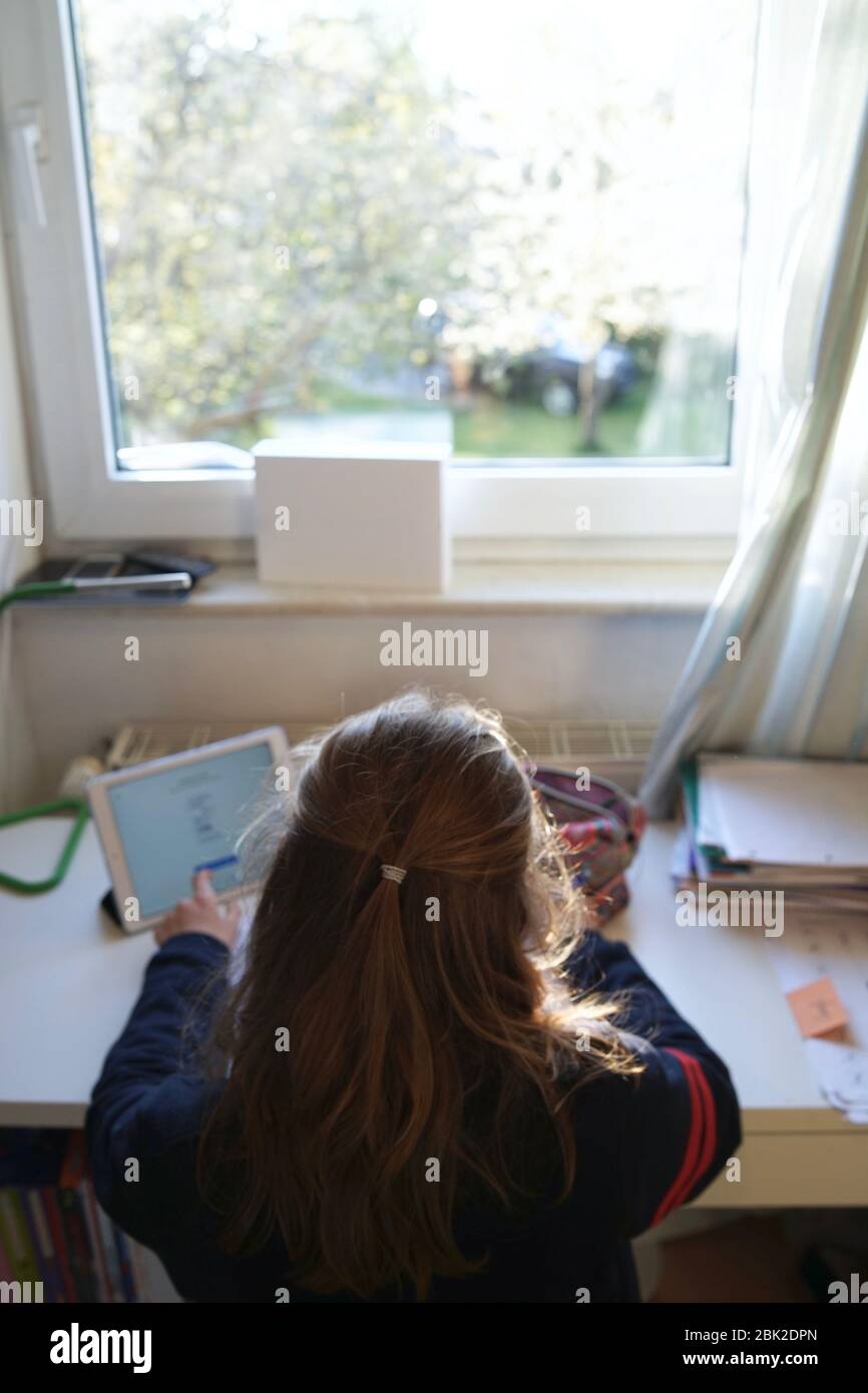 Real 10 year old girl is doing homeschooling, learning at home, doing ...