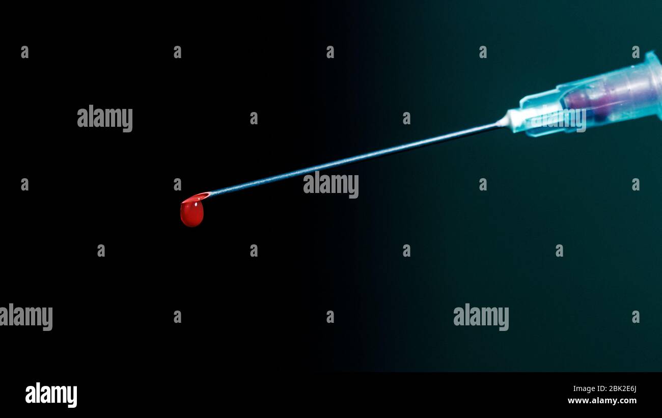 Syringe with blood isolated on dark background, closeup Stock Photo - Alamy