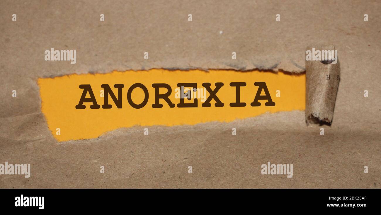 Anorexia word appearing behind brown torn paper. Eating disorders women ...
