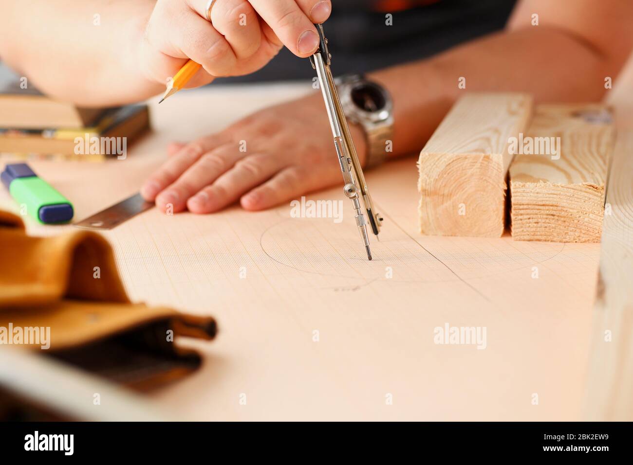 Arms of worker making structure plan on scaled paper Stock Photo - Alamy