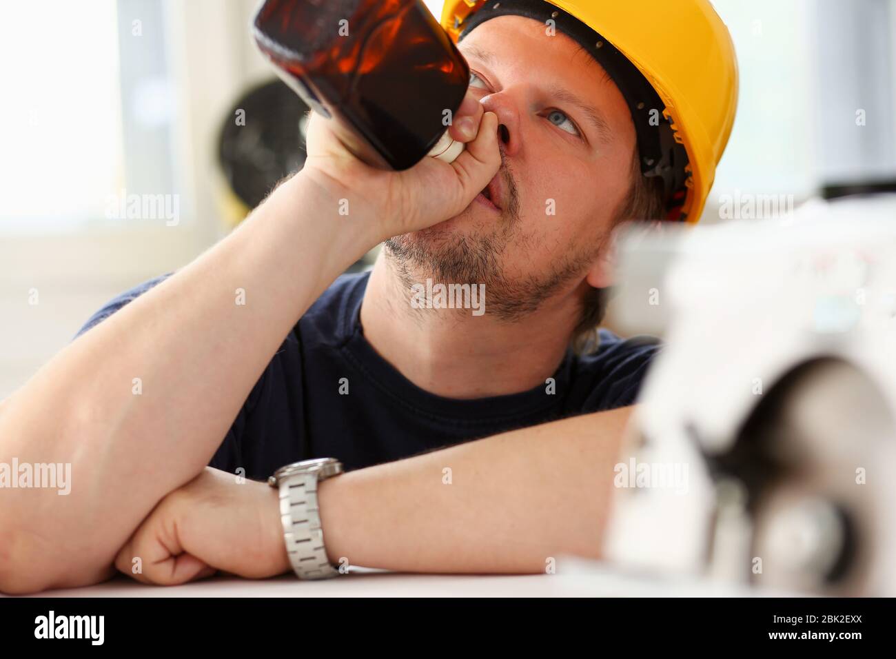 Arm of drunken worker in yellow helmet Stock Photo - Alamy