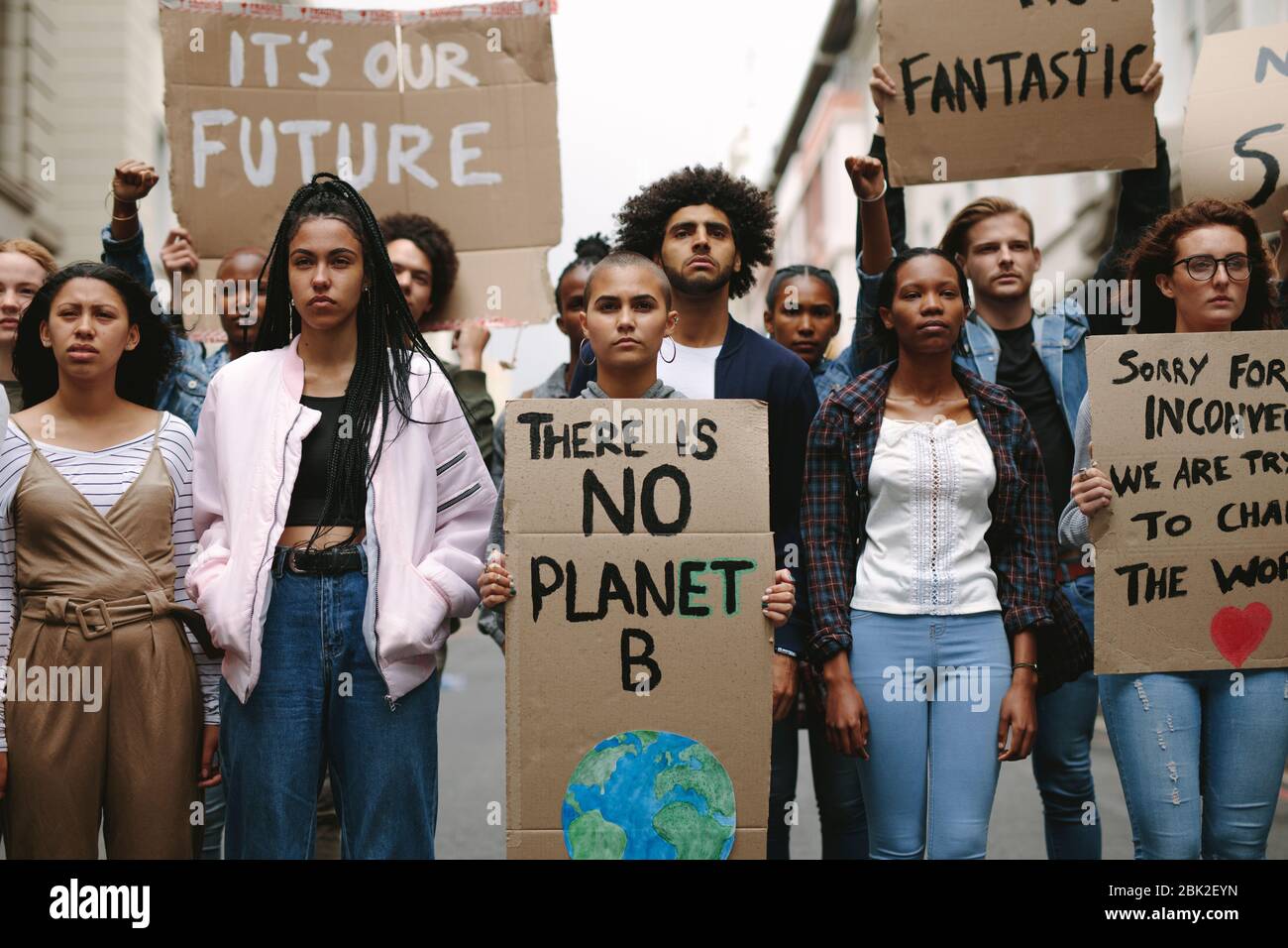 Group of activists with banners protesting to save earth. Men and women ...