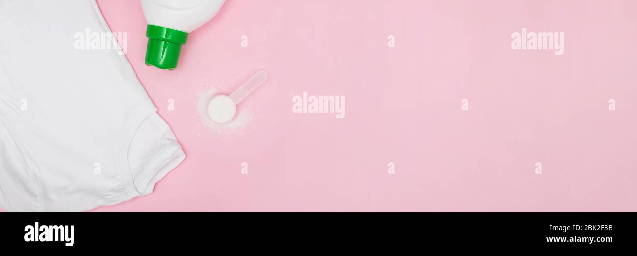 Clean white t-shitr, powder washing detergent and plastic bottle of ...